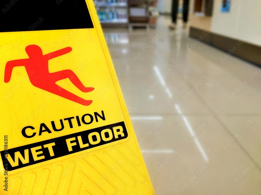 Focus on warning sign beware slippery floor and blur background of ...