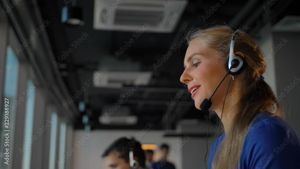 Friendly customer call center service adviser talking to a customer ...