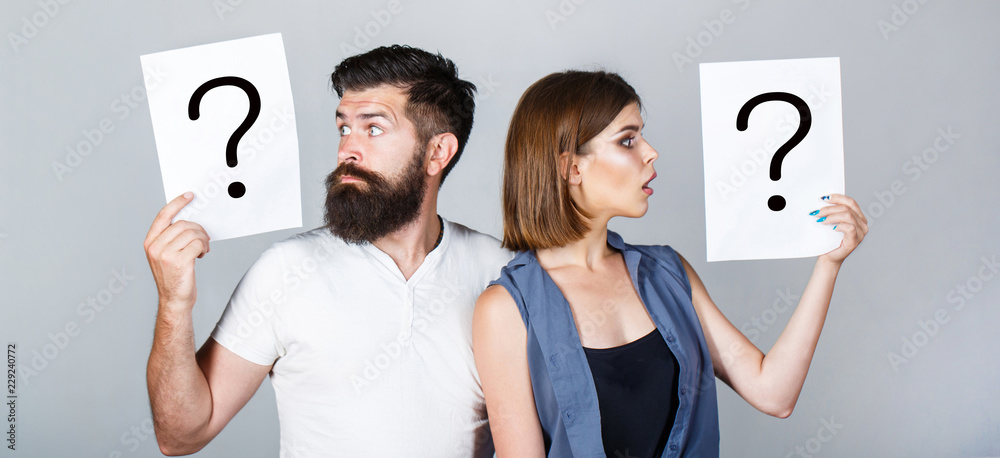 Portrait of couple holding paper question mark. Couple thinking about ...