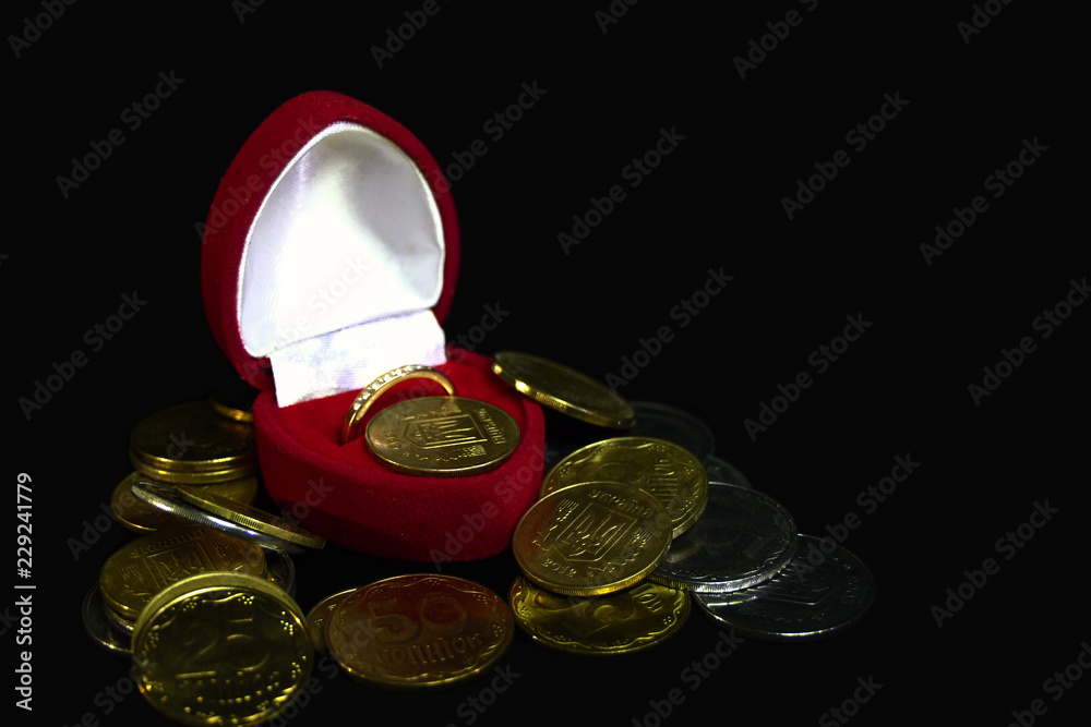red velvet gift box with a gold ring and diamonds on a black background ...