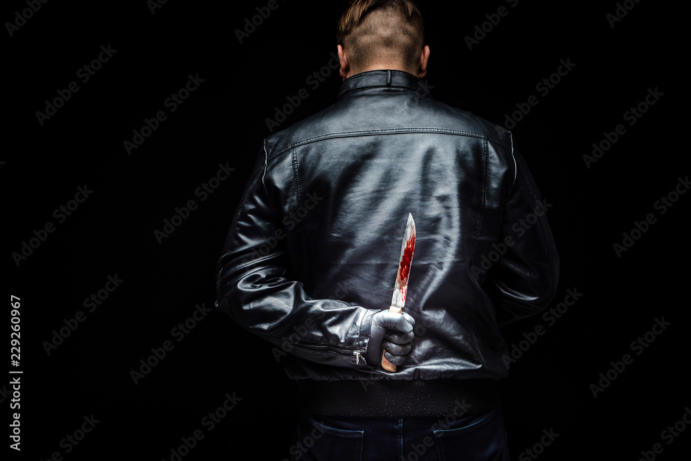Serial killer maniac holding killer tools behind his back Stock Photo ...