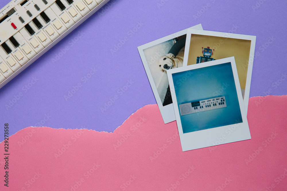 Polaroid photo of a keyboard on pink and violet ripped edge paper with ...