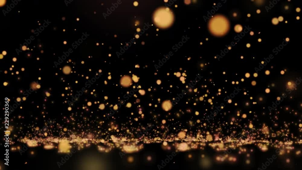 Golden particles fall to the ground and explode into small particles ...