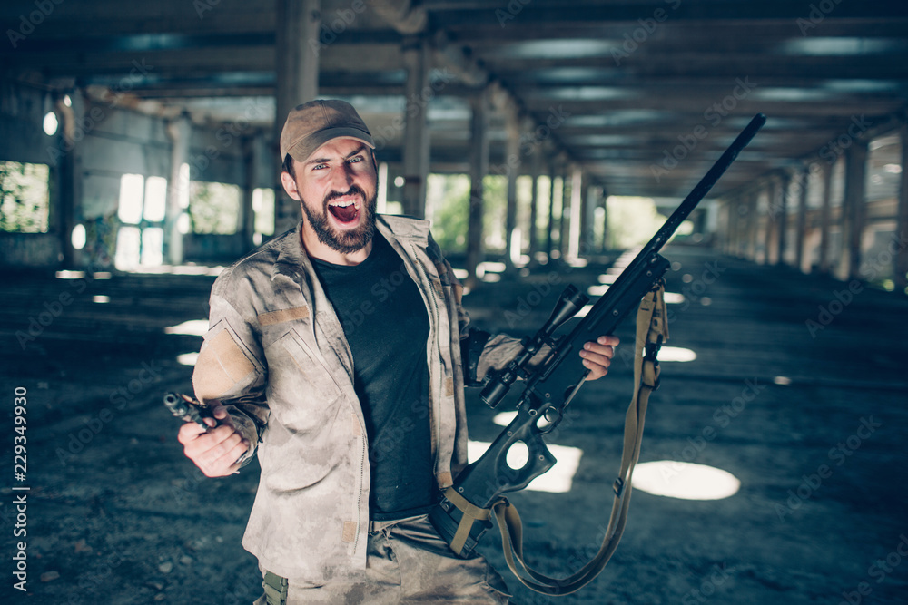 Courageous and fearless bearded man is standing and screaming. He is ...