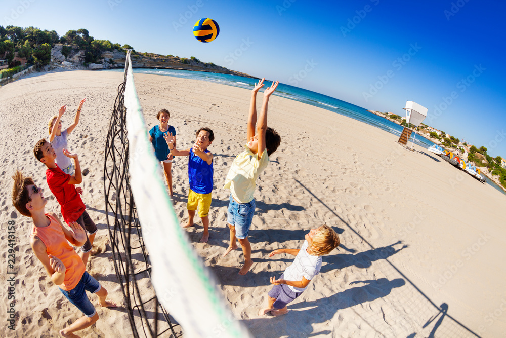 Happy children playing volleyball on the beach Stock Photo | Adobe Stock