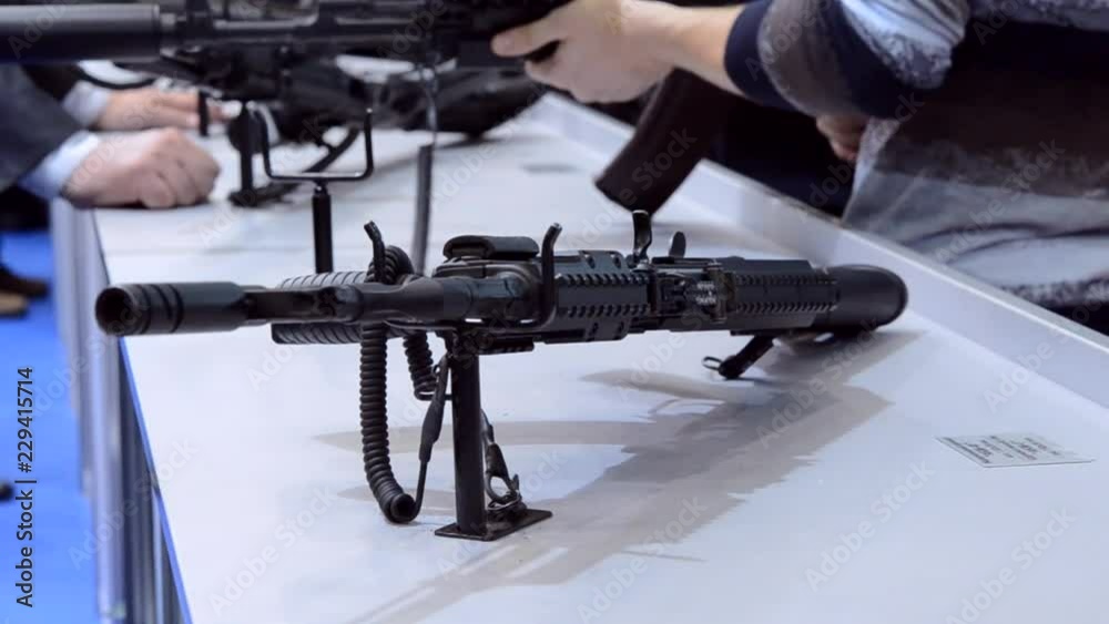 Several large-caliber weapons on the table. Firearms gun submachine ...