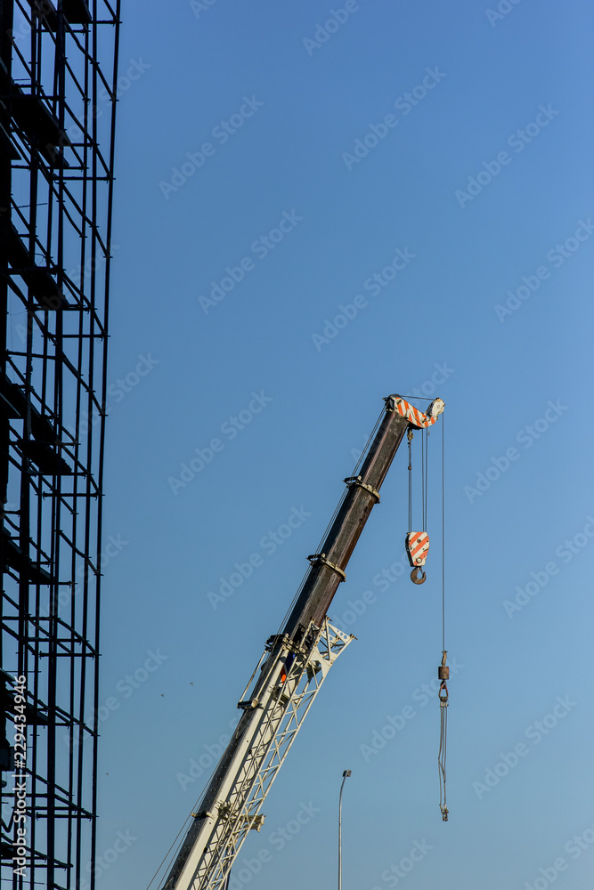 Construction of the house with the help of trucks. Manipulator at a ...