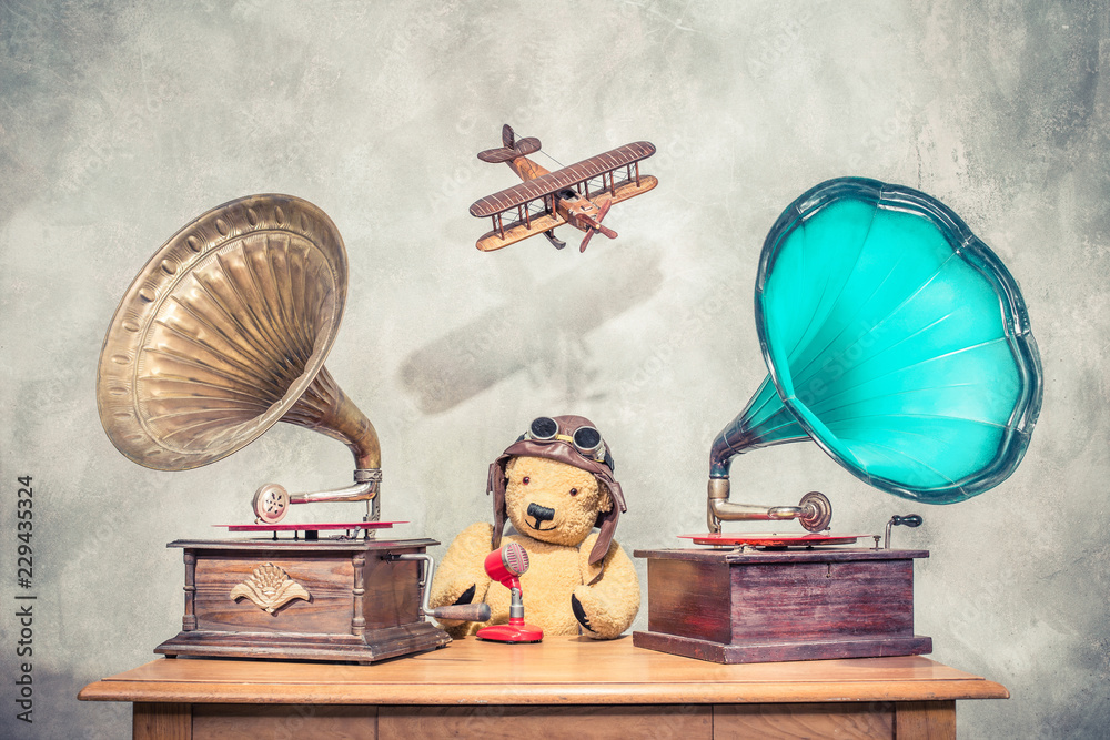 Teddy Bear with aviator's helmet and goggles, aged antique gramophone ...