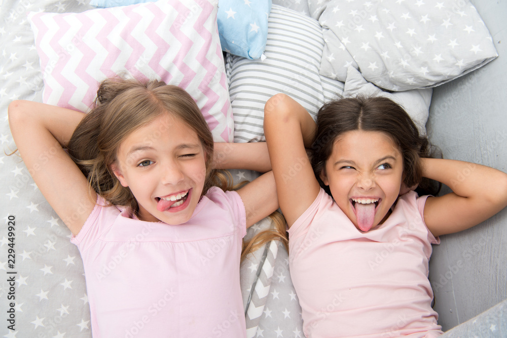 Slumber party timeless childhood tradition. Girls relaxing on bed ...