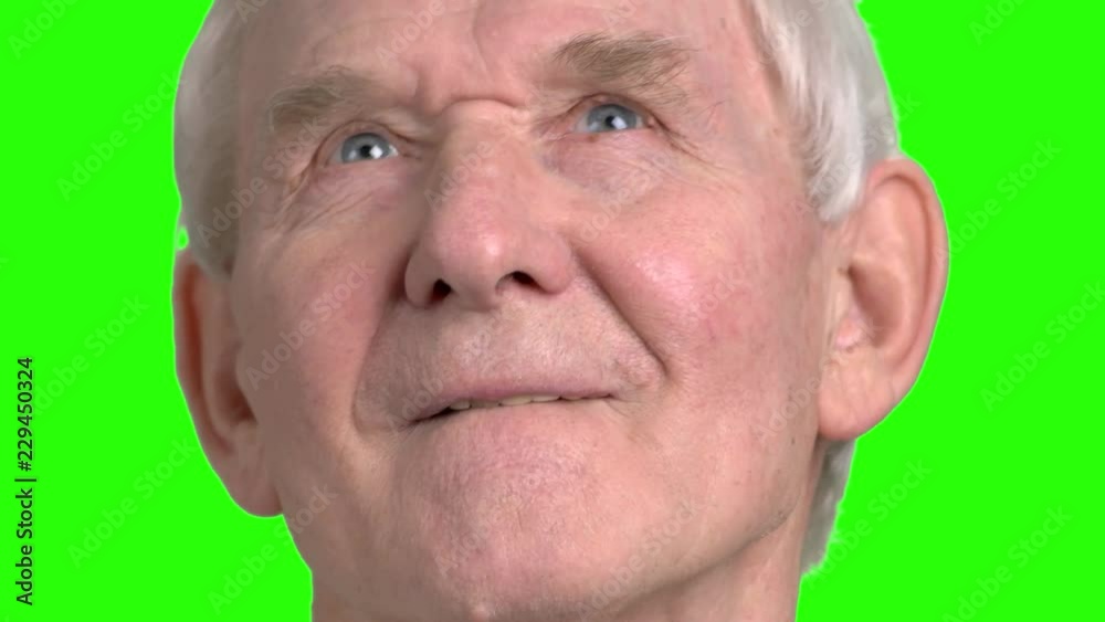 Close up old man face looks up. Macro front view grandpa face looks up ...