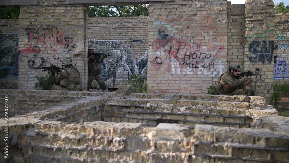 Counterterror squad of rangers equipped and armed entering ruined ...