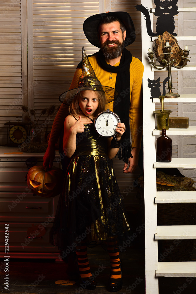 Beautiful fairy and wizard. Father and child celebrate halloween. Treat ...