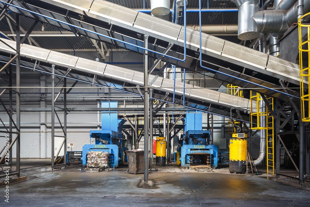 garbage press on modern waste recycling processing plant. Separate ...