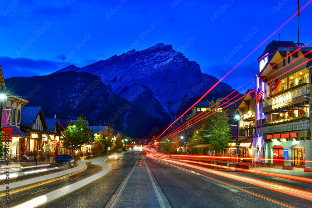 Street view of famous Banff Avenue at twilight time. Banff is a resort ...