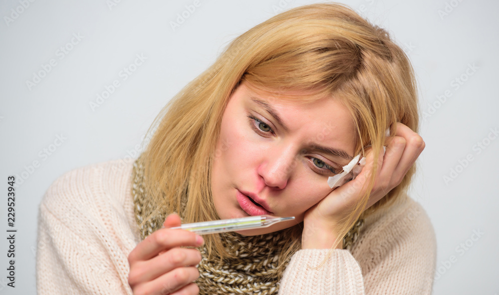 Take temperature and assess symptoms. High temperature concept. Woman ...