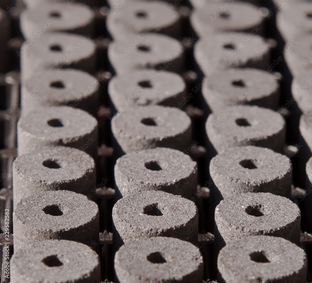 50 caliber black powder pellets for a muzzle loader rifle lined up in a ...