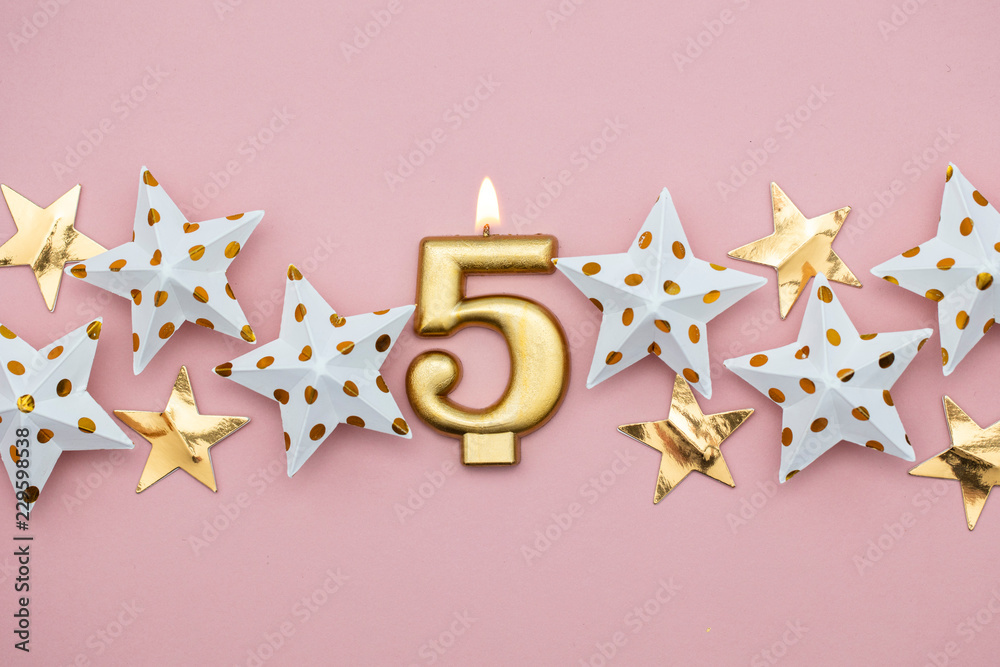 Number 5 gold candle and stars on a pastel pink background Stock Photo ...