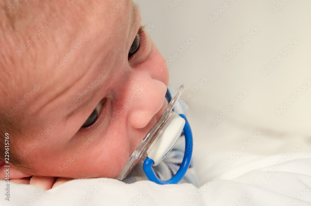 Newborn two weeks old baby boy laying down on white sheet awake Stock ...
