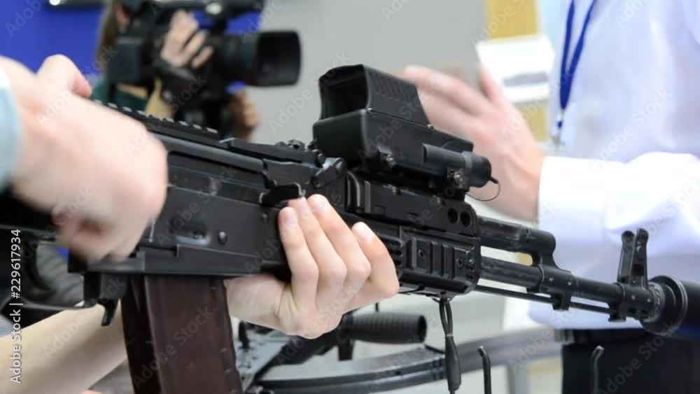 Submachine Gun on the table close-up. Several large-caliber weapons on ...