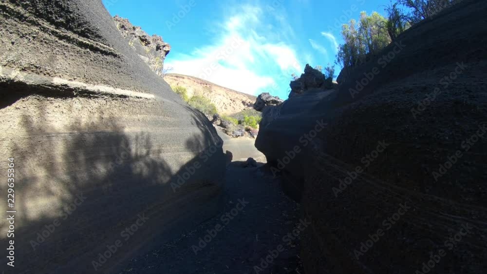 Walking inside volcano malacara grey debris, dry river of vocanic ...