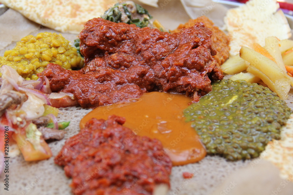 A plate of Ethiopian vegetarian vegan fasting food on "injera" brown ...