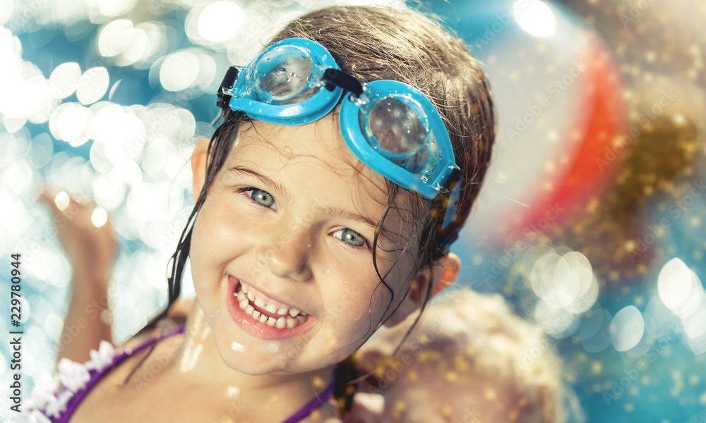 Beautiful little girl sunning at the pool Stock Photo | Adobe Stock