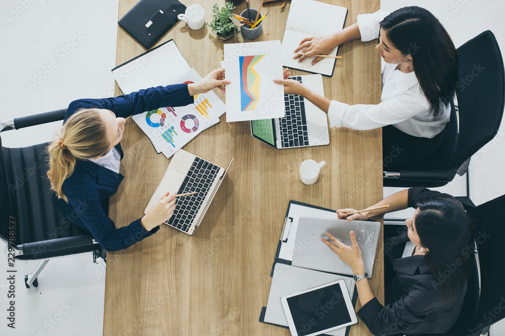 Top view of businessmen and businesswoman standing and stacking hands ...