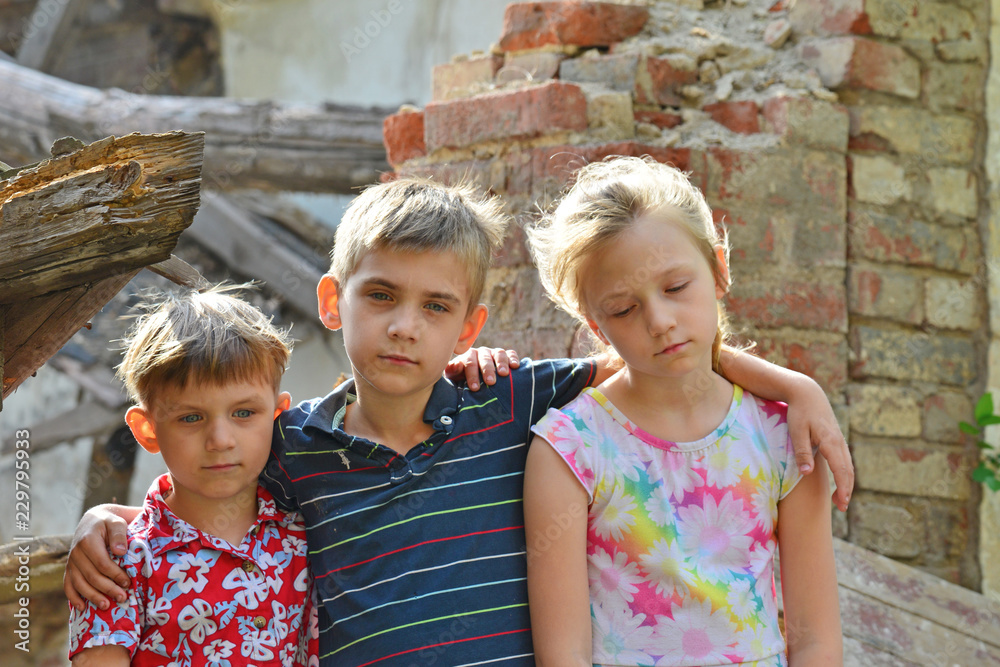 Children are near the ruined house, the concept of natural disaster ...