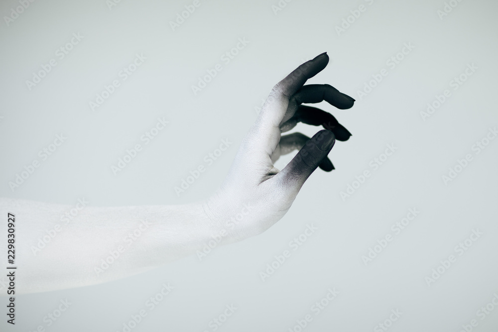 Creepy Halloween monster hand with white and black make up in front of ...