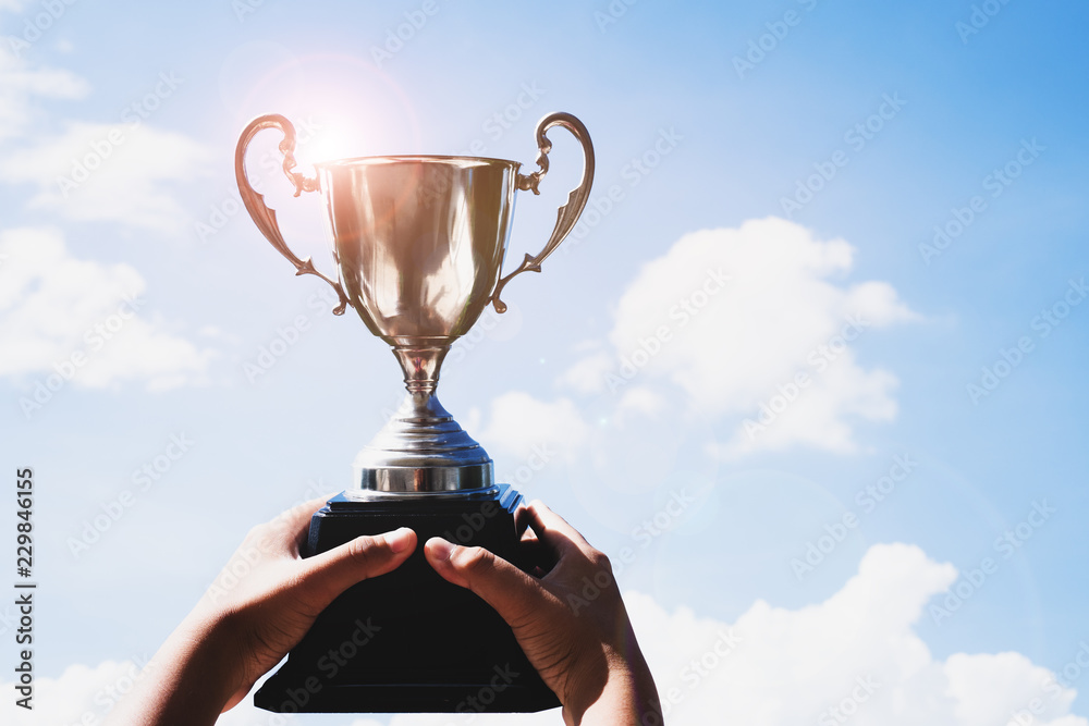 Leadership of champion trophy placed on hand raised holding for award ...