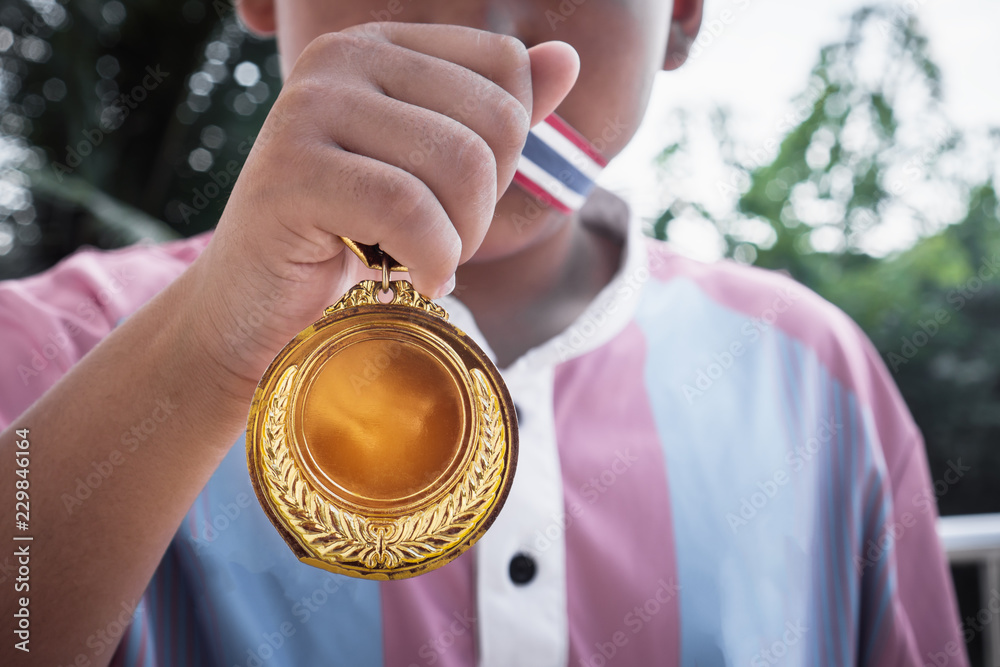 Asian boy Winner hand raised medals Awards of competition concept ...