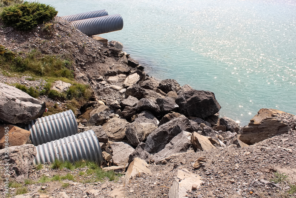 Four culverts next to a body of water Stock Illustration | Adobe Stock