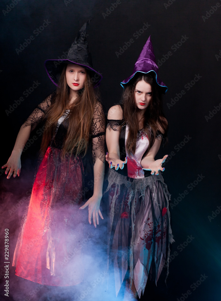 Two witches in colorful costumes in dynamic pozahi acting game. Two ...