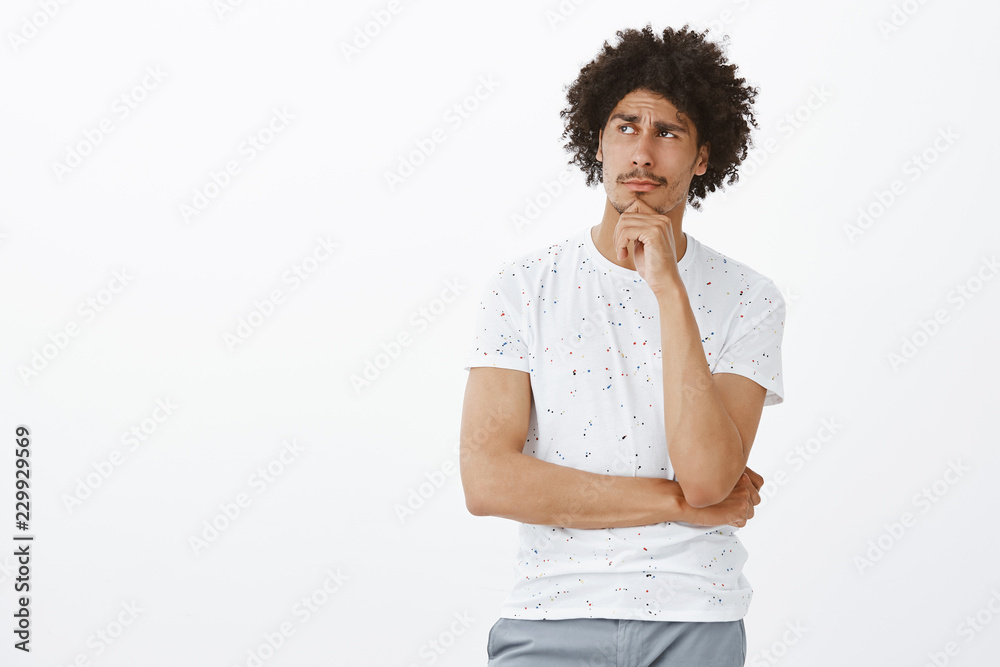 Handsome guy thinking if he did right thing. Thoughtful relaxed and ...