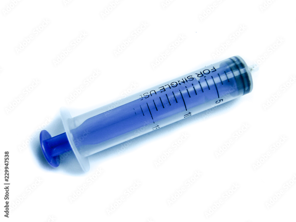 Disposable syringe of blue color without needle on the white isolated ...