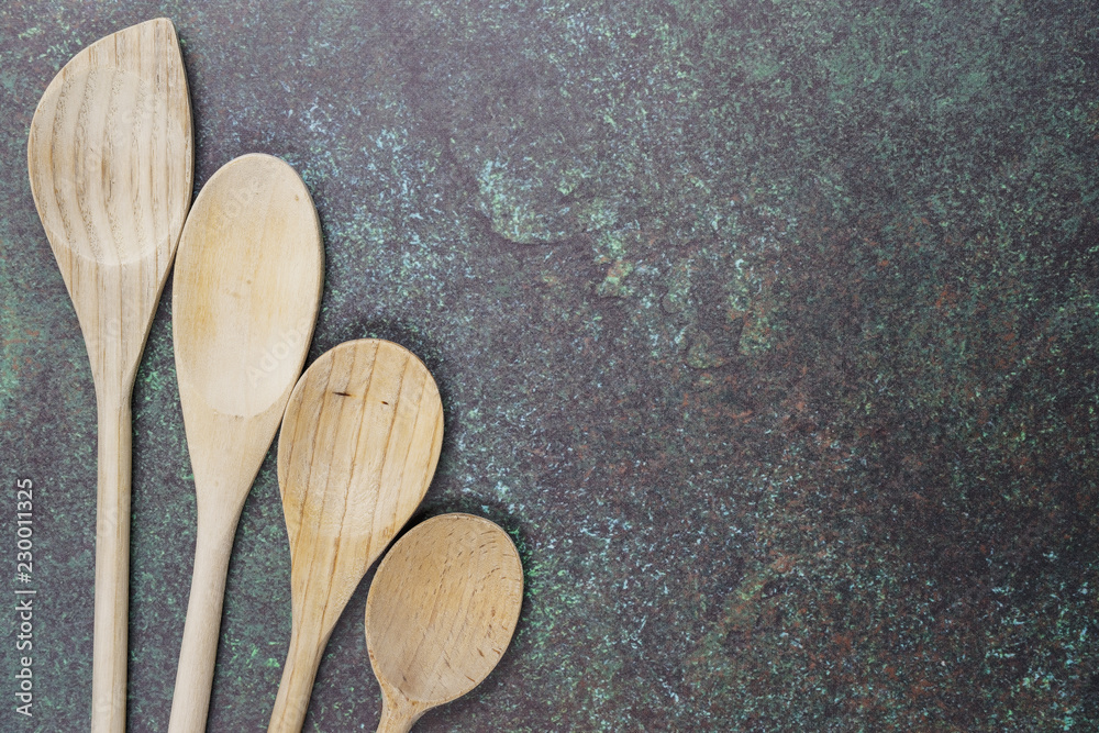 angled wooden spoon corner border on a blue green counter top Stock ...