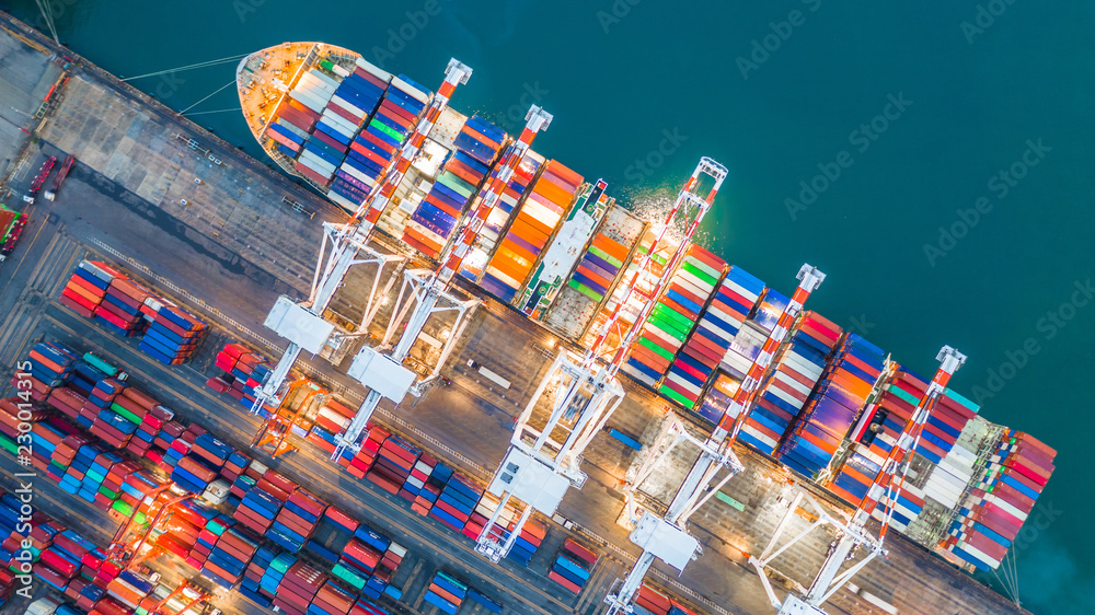 Aerial top view crane shipping container at night, cargo container ship ...
