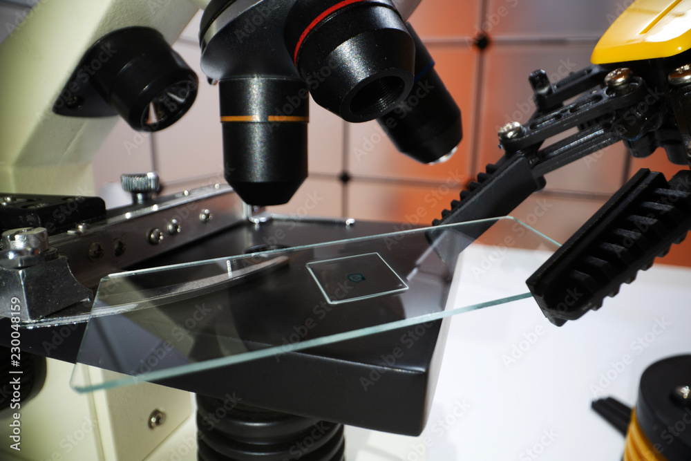 Microscope slide in robot arm and science microscope Stock Photo ...