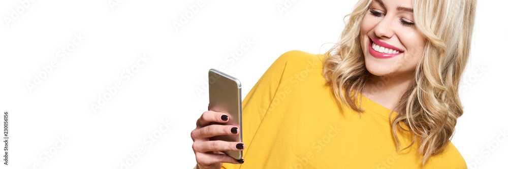 Gorgeous smiling woman looking at her mobile phone. Woman texting on ...