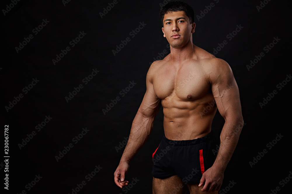 Strong Athletic man with perfect body. isolated on black background ...