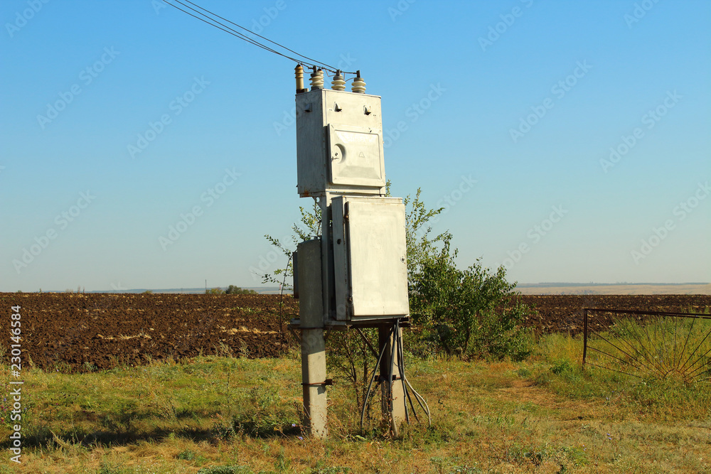 Transformer substation in a field by the road. Close-up. Background ...