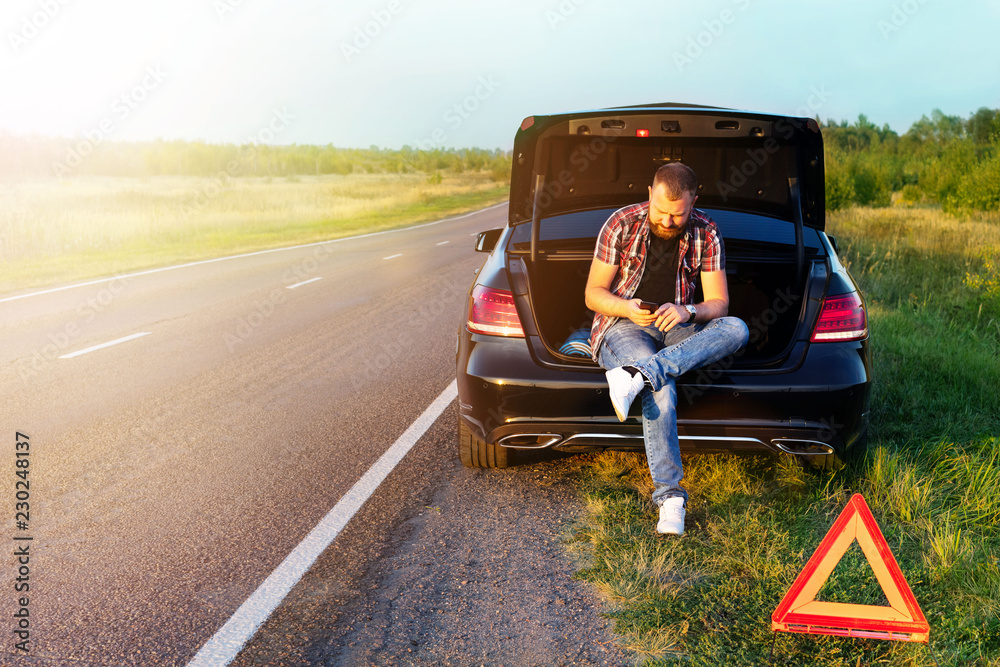 car broke down on the road, a man calls the emergency service, a tow ...