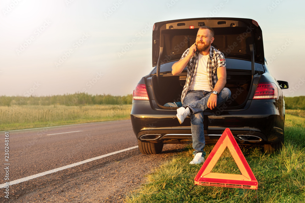 car broke down on the road, a man calls the emergency service, a tow ...