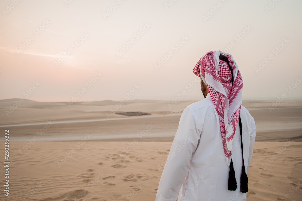 Arab man in the desert is meeting sunrise Stock Photo | Adobe Stock