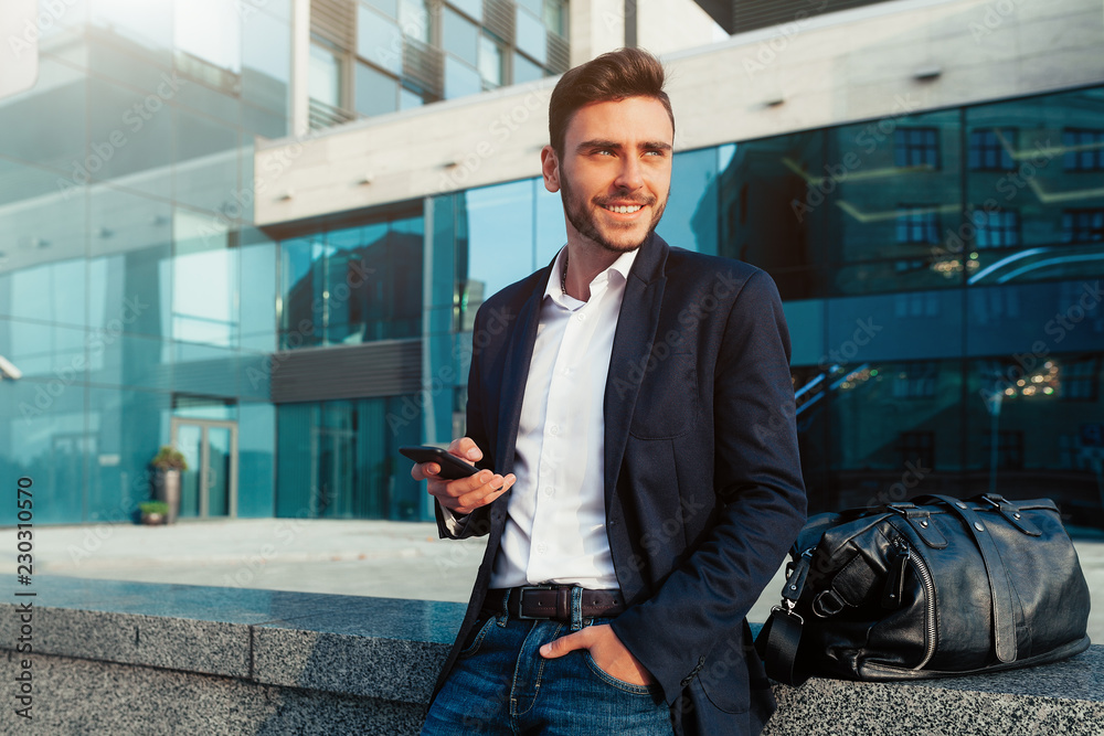 Millennial businessman with a mobile phone in his hands. Young ...