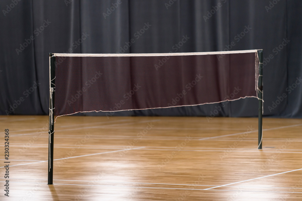 wooden floor badminton court and nets. Wooden floor of sports hall with ...