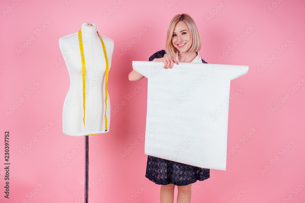 sewing pattern,sewing machine and maniken in studio pink background ...