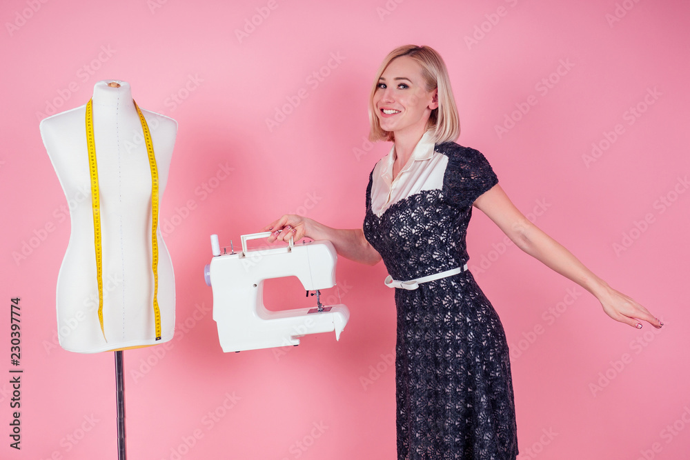 sewing pattern,sewing machine and maniken in studio pink background ...