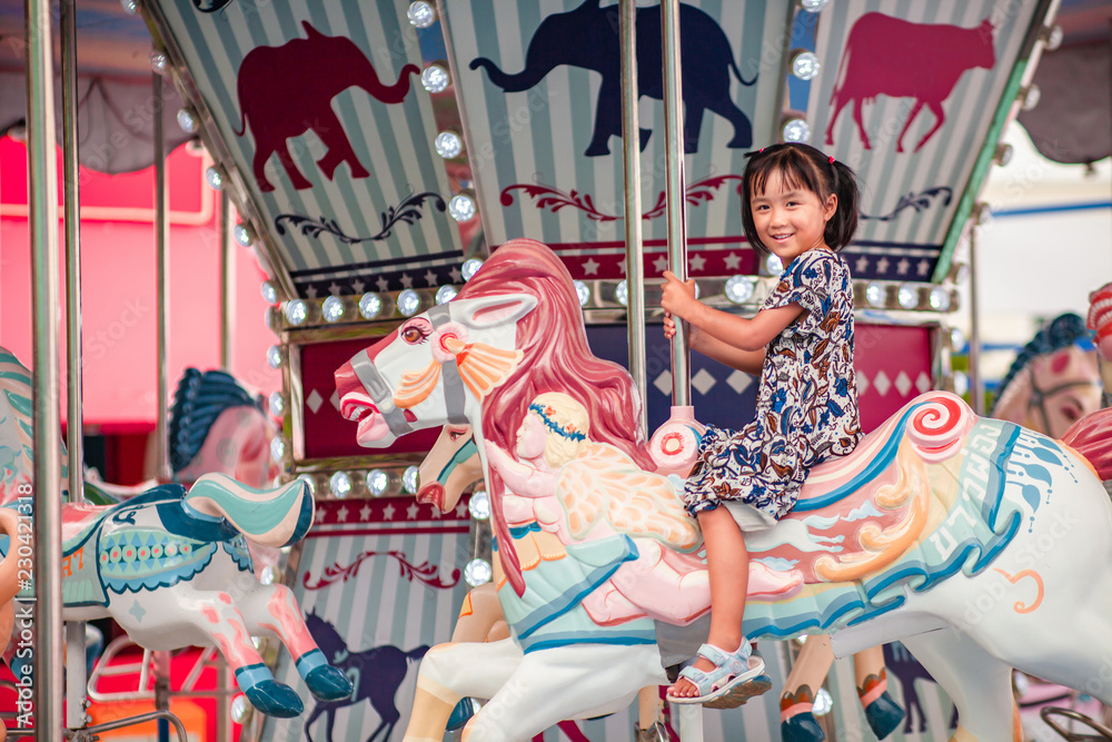 kids and Carousel . little girl is happy, enjoy playing the carousel ...