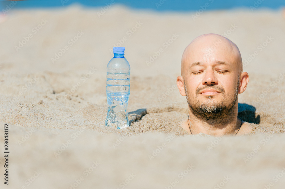 Buried till head bald man. Suffering of thirsty male in desert. Young ...